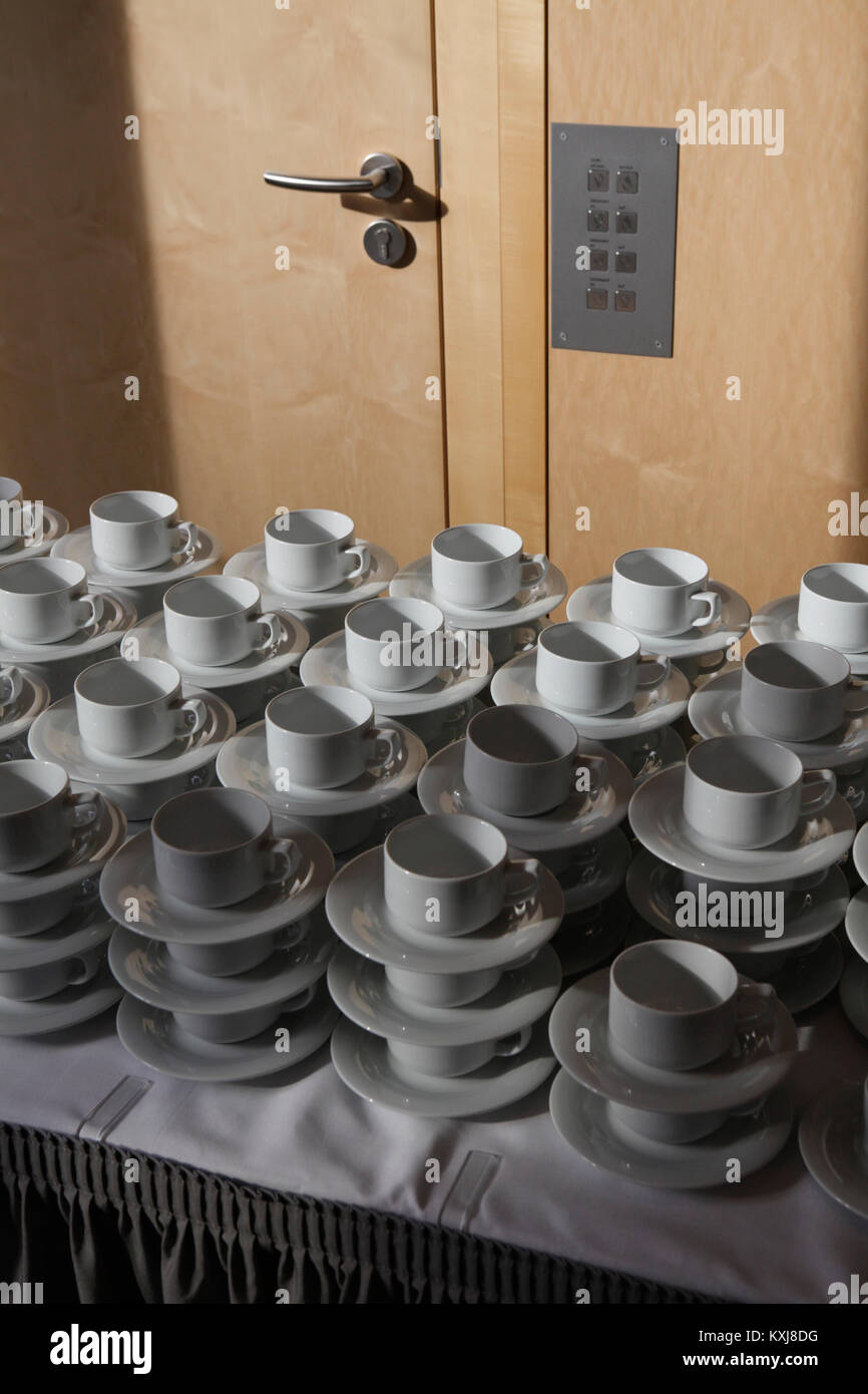 High angle view of stacked cups and saucers in cafe Stock Photo - Alamy
