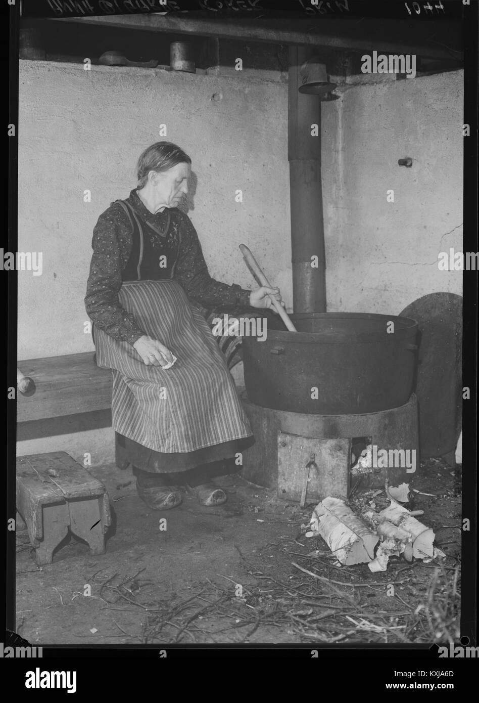 This photograph shows Anna Øigarde preparing traditional Norwegian food ...