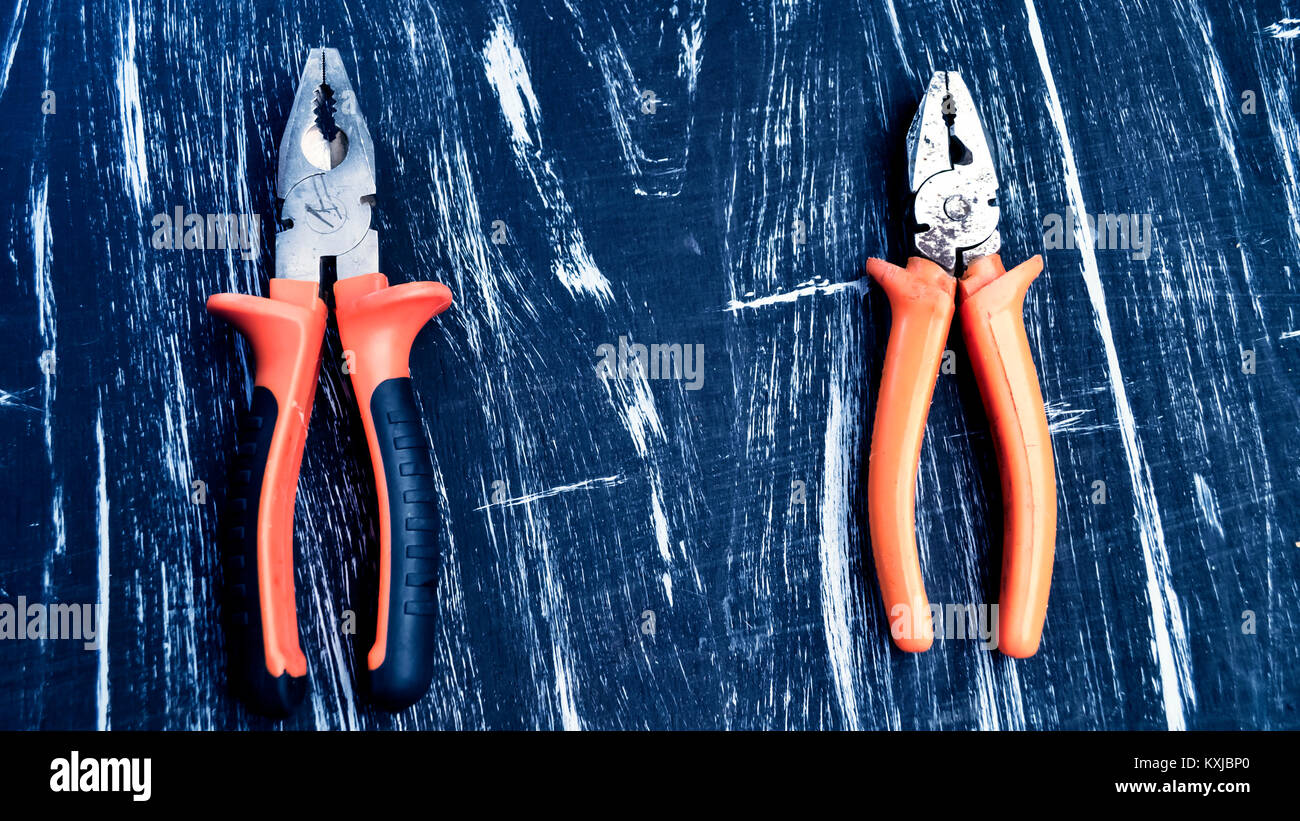 Pliers for repair work lying on the table. Repair tools in the h Stock ...