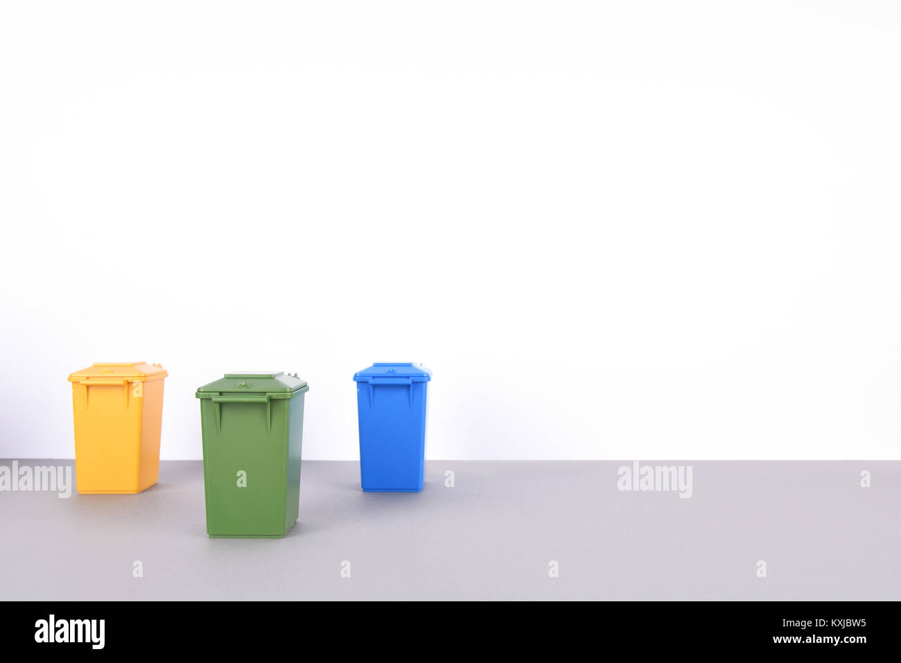 Colorful recycle bins on white background Stock Photo - Alamy