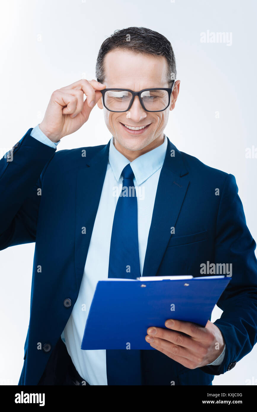 Happy delighted man looking at the documents Stock Photo - Alamy