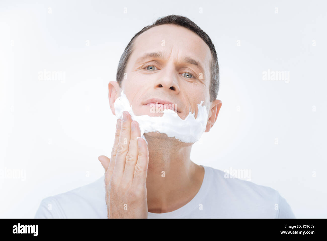 Handsome brutal man applying shaving foam Stock Photo - Alamy