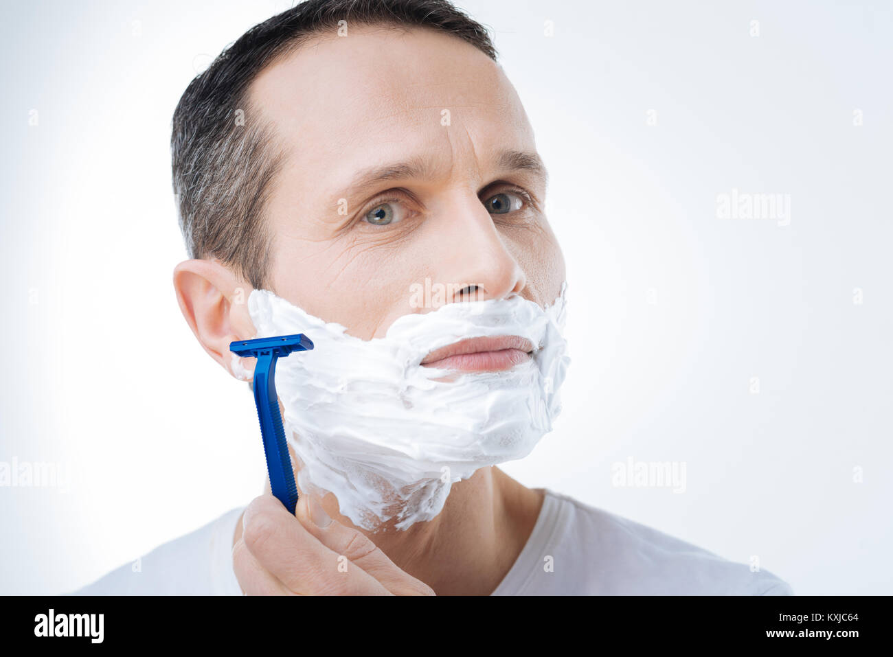 Portrait of a nice pleasant man shaving Stock Photo - Alamy