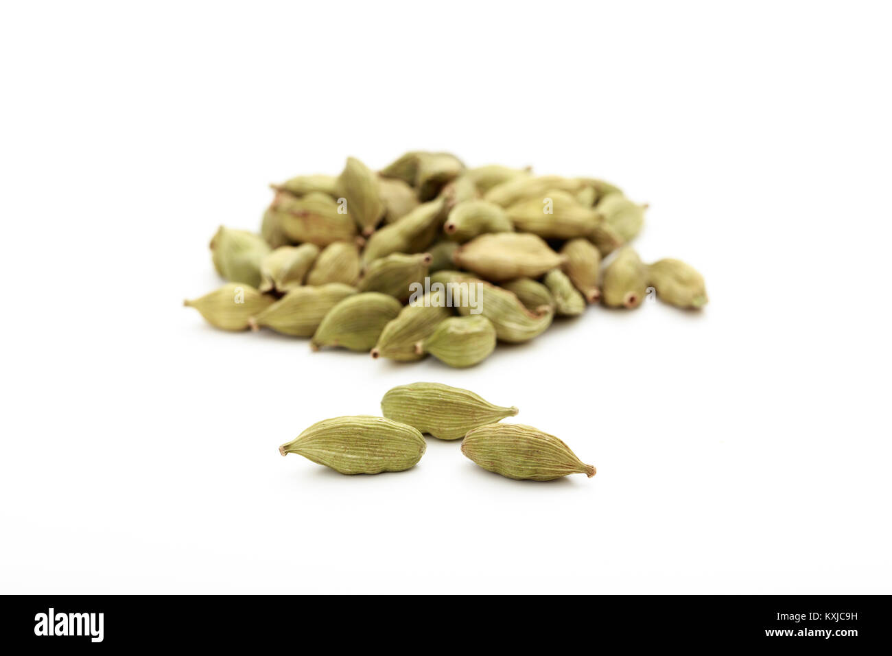 Cardamom seeds on white background Stock Photo - Alamy