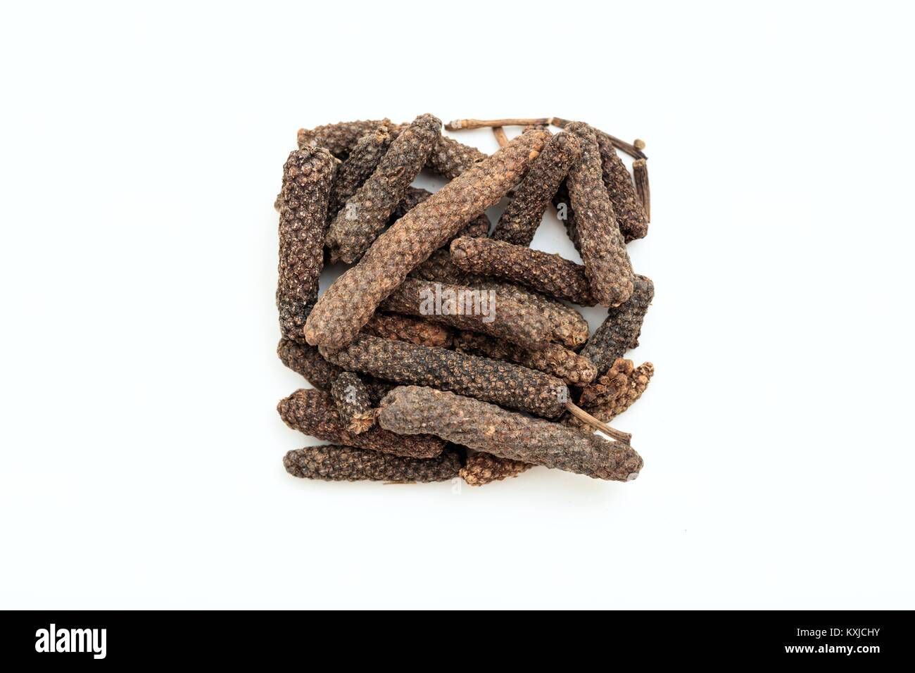 Long pepper seeds on white background Stock Photo - Alamy
