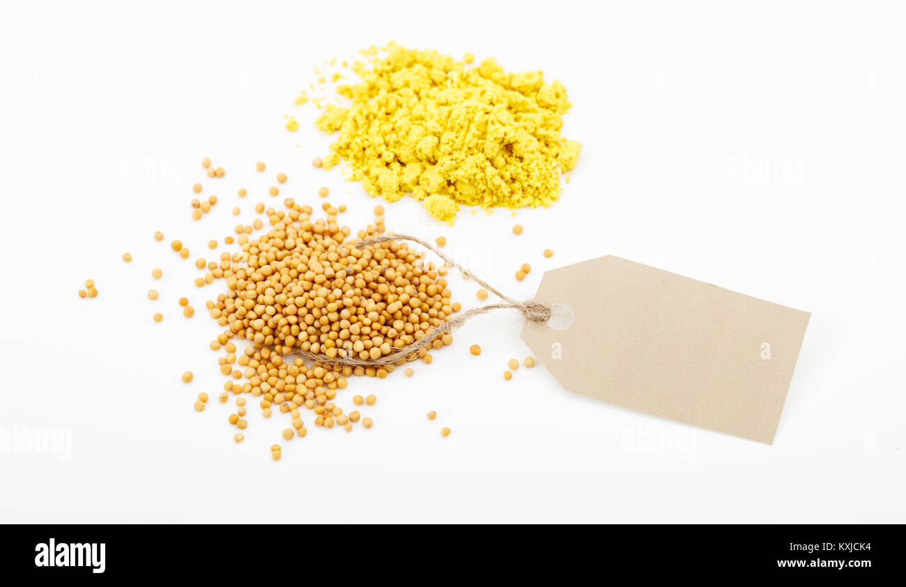 Mustard seeds and powder with label on white background Stock Photo - Alamy