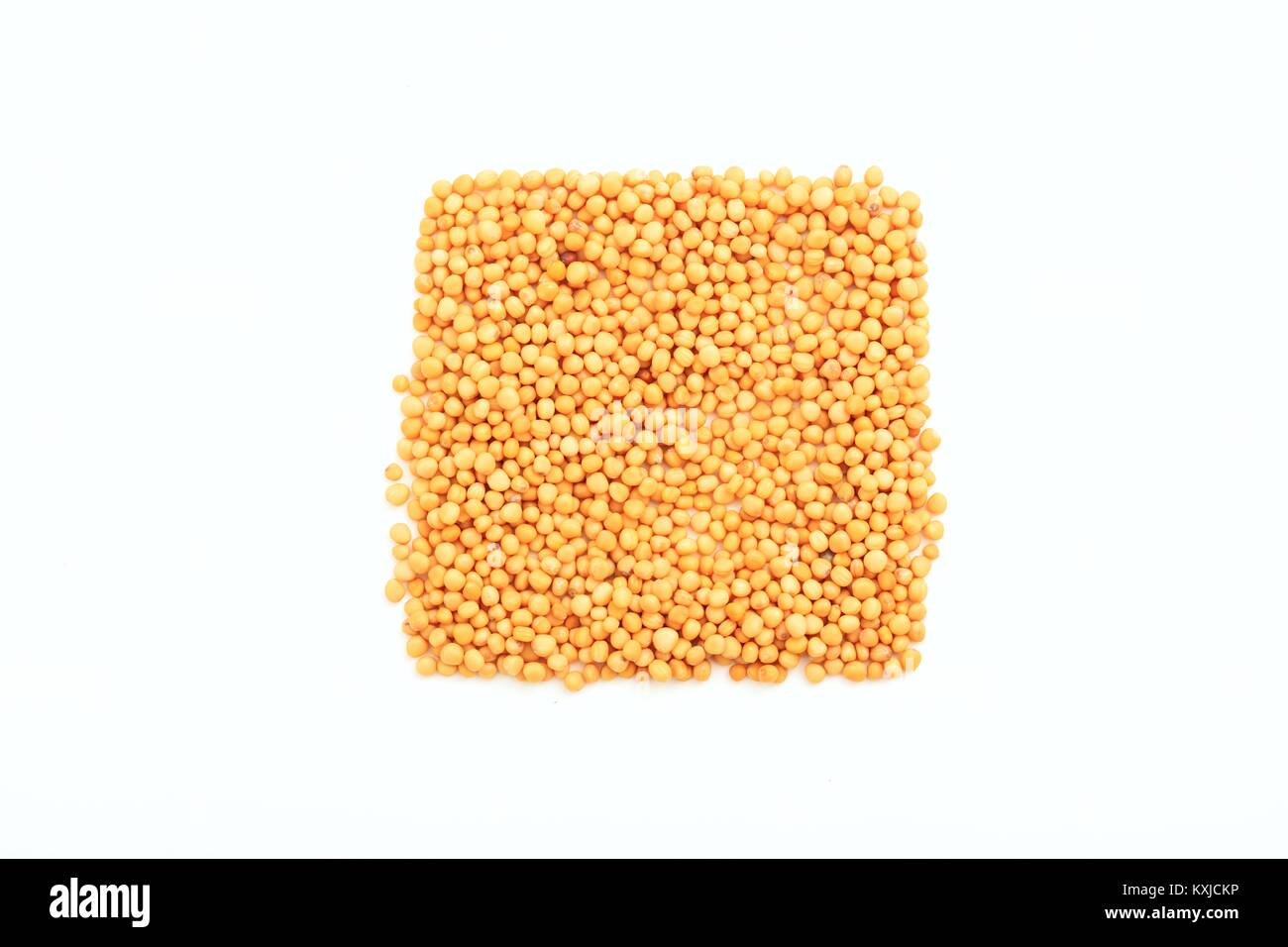Mustard seeds in a square shape on a white background Stock Photo - Alamy