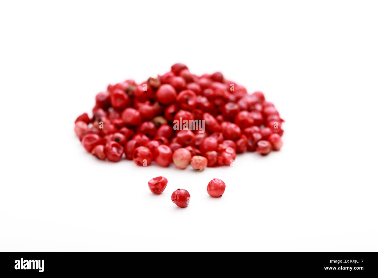 Red pepper seeds on white background Stock Photo - Alamy