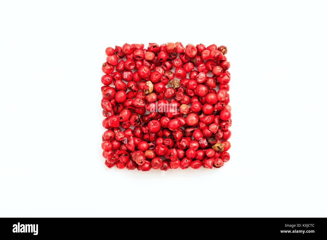 Red pepper seeds on white background Stock Photo - Alamy