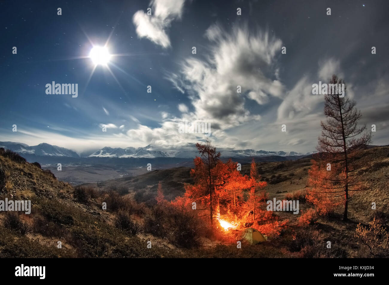 Camp tent at night fire desert steppe on a highland mountain plateau on ...