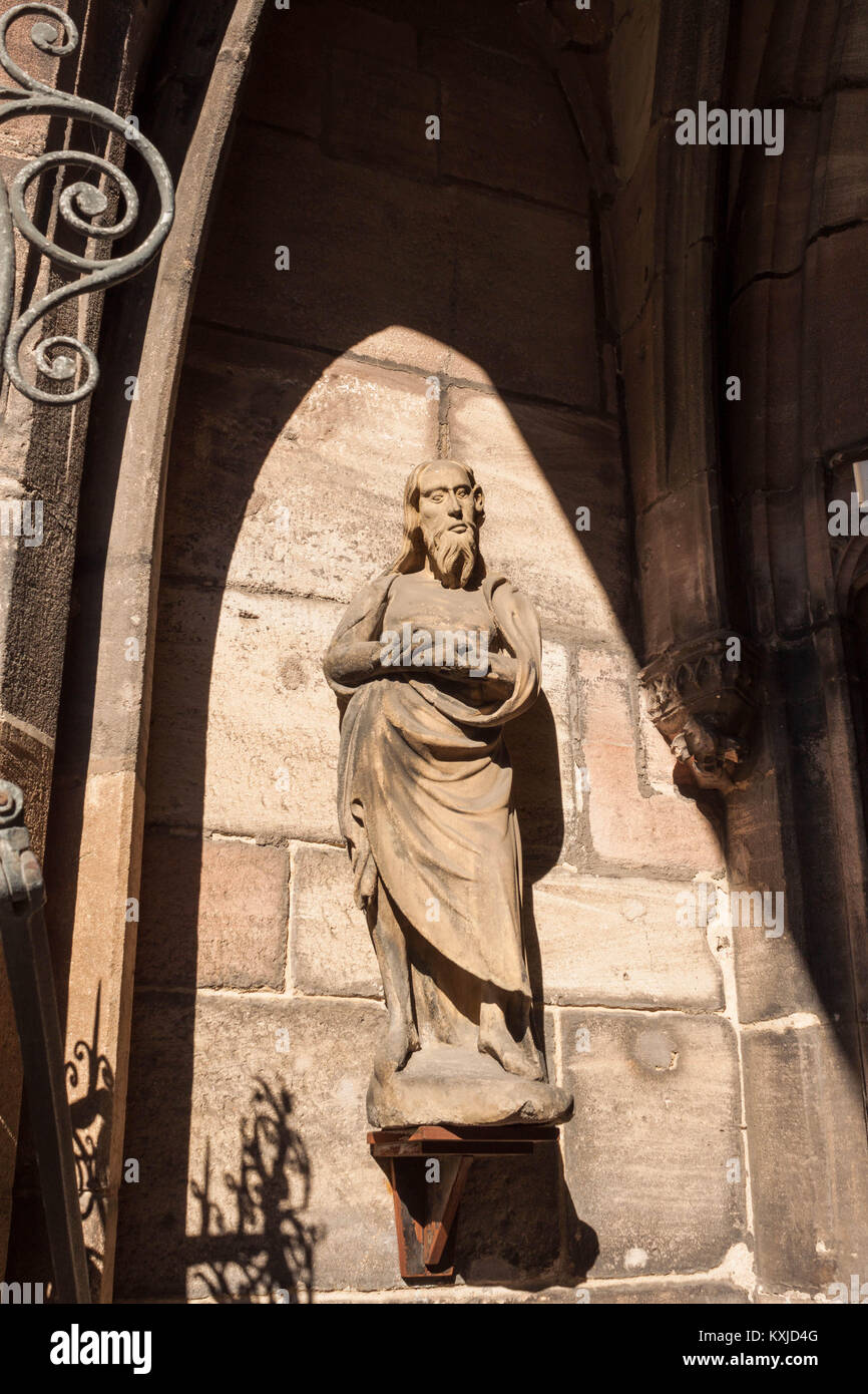 Eavesdropping man statue with big ear in portal of south door of St ...