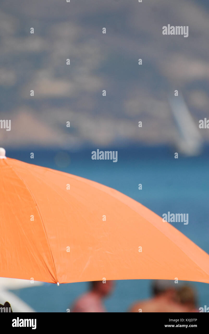 Albir, Spain - September 11 2011: A bright orange beach brolly in the ...