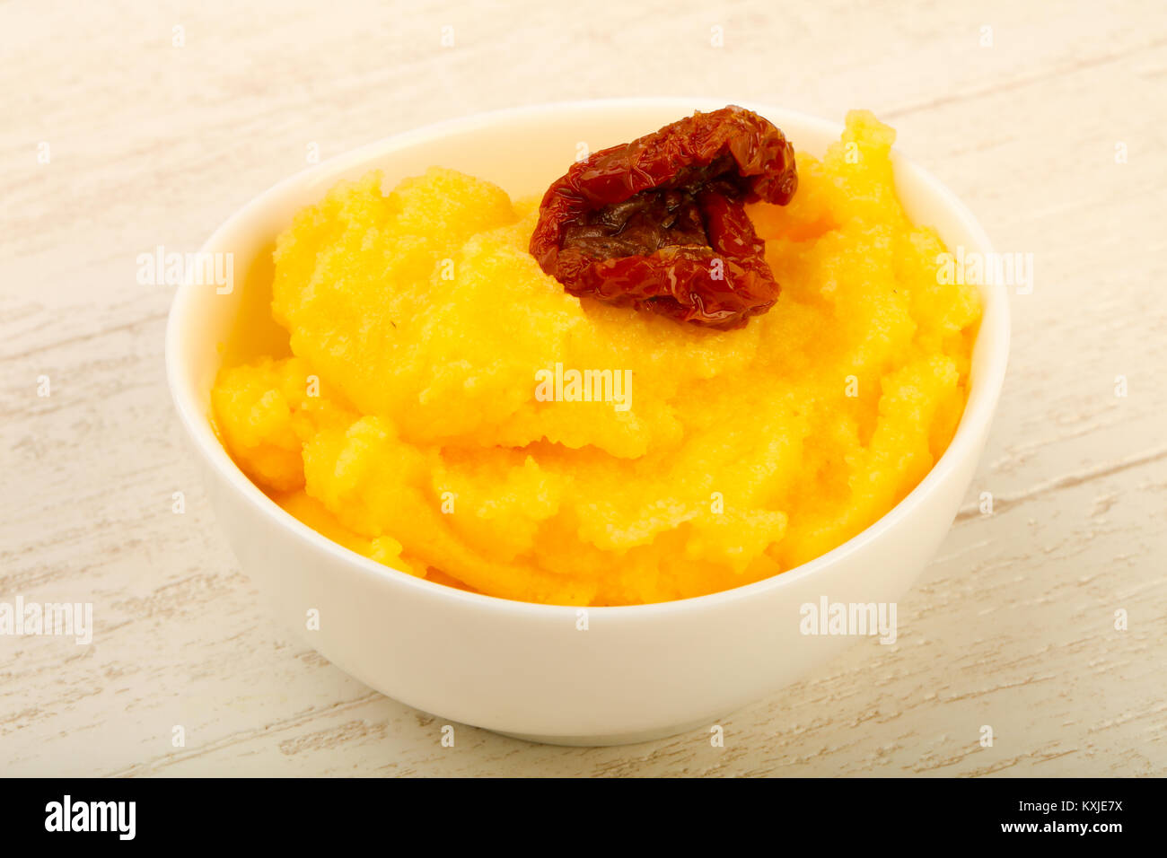 Polenta with dry tomato Stock Photo - Alamy