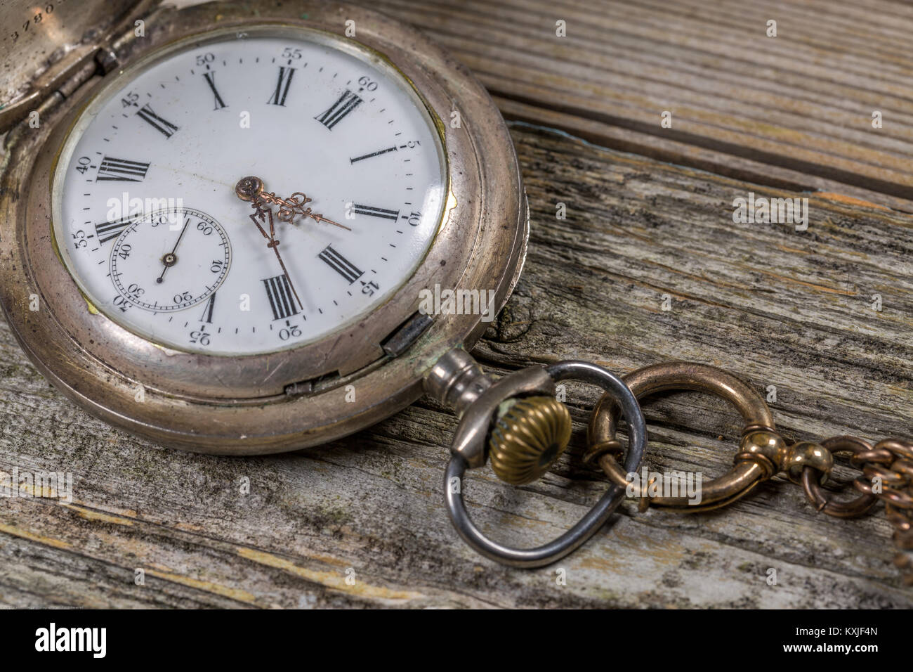 Antique pocket watch lying on an old rustic wood background Stock Photo ...