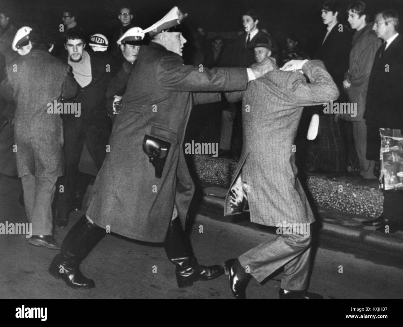 Police officers arresting demonstrators in Berlin on December 17,1966 ...