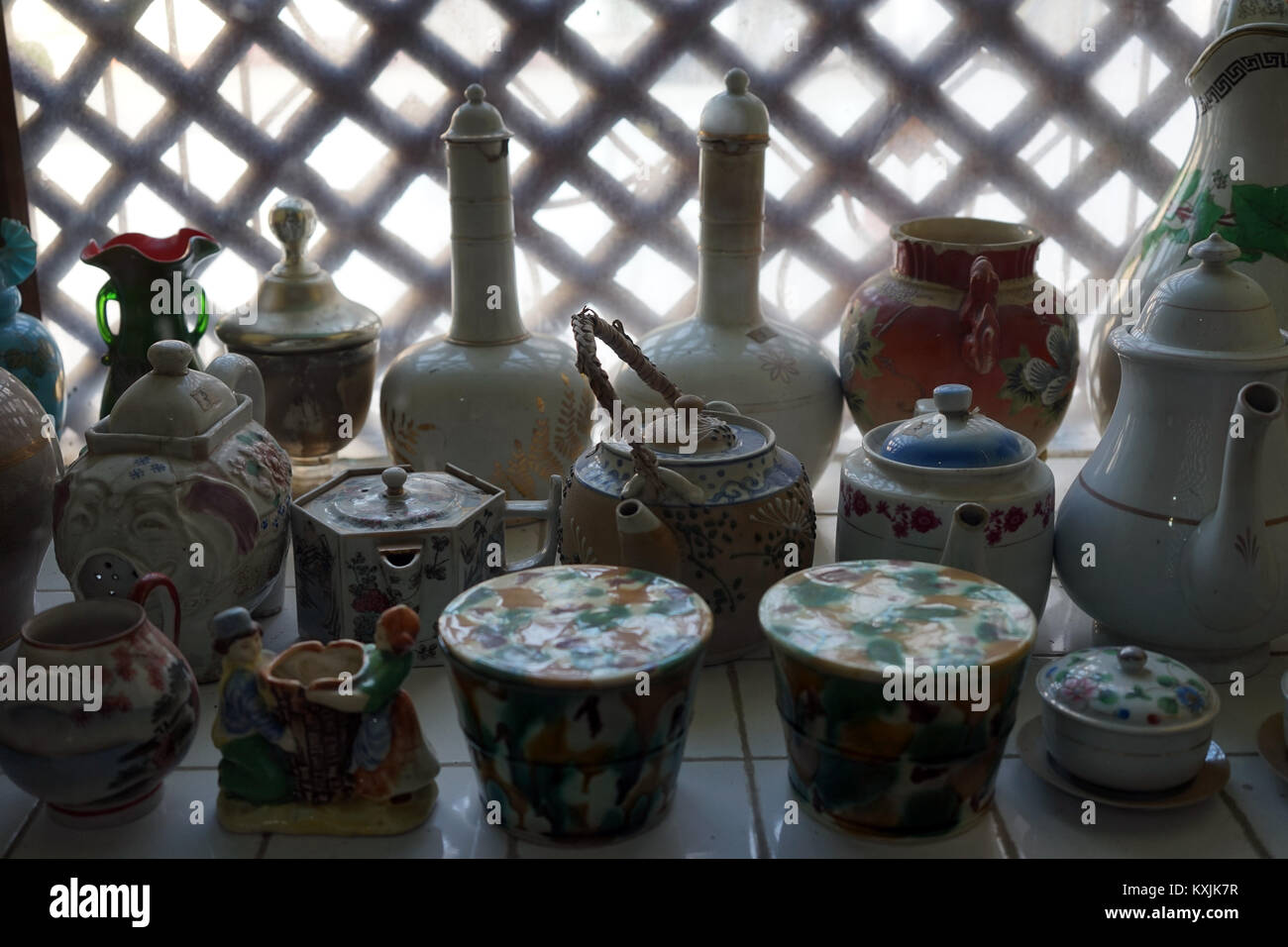 Old tea pots in the window Stock Photo - Alamy