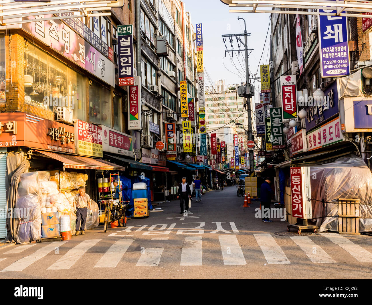 Seoul, South Korea. People walking down a small street near ...