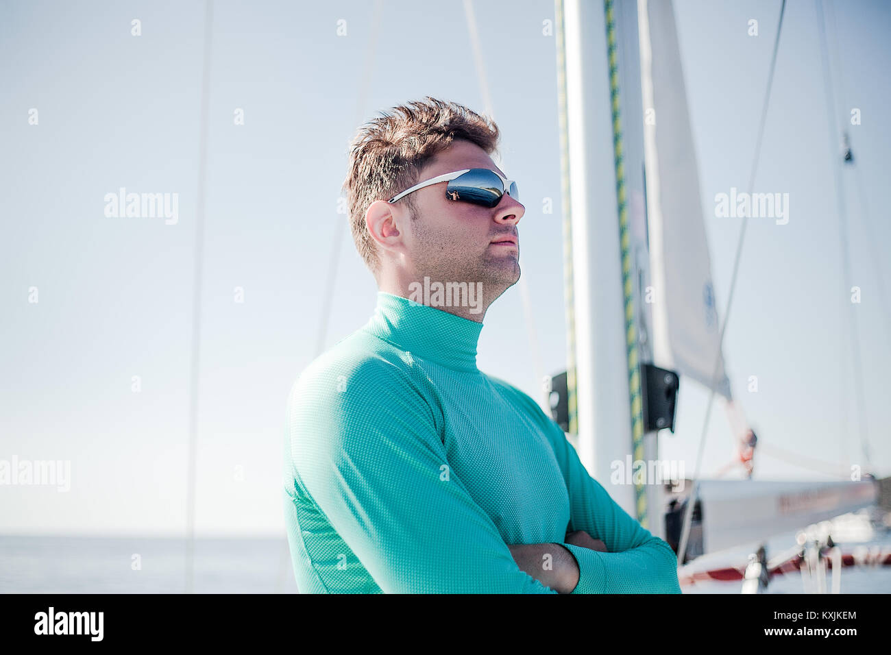 Man on sail boat Stock Photo - Alamy