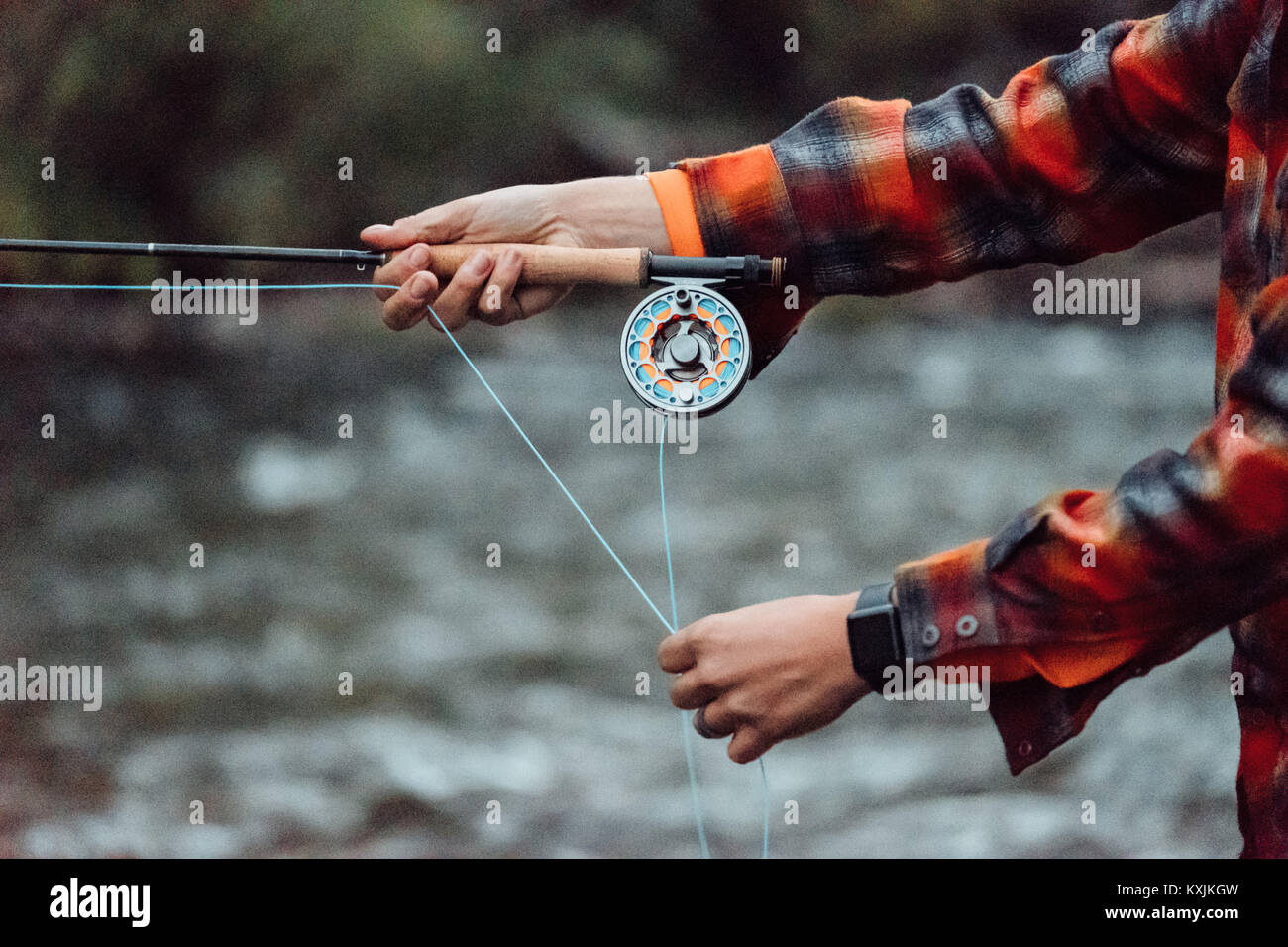 Cropped view of man fishing Stock Photo - Alamy