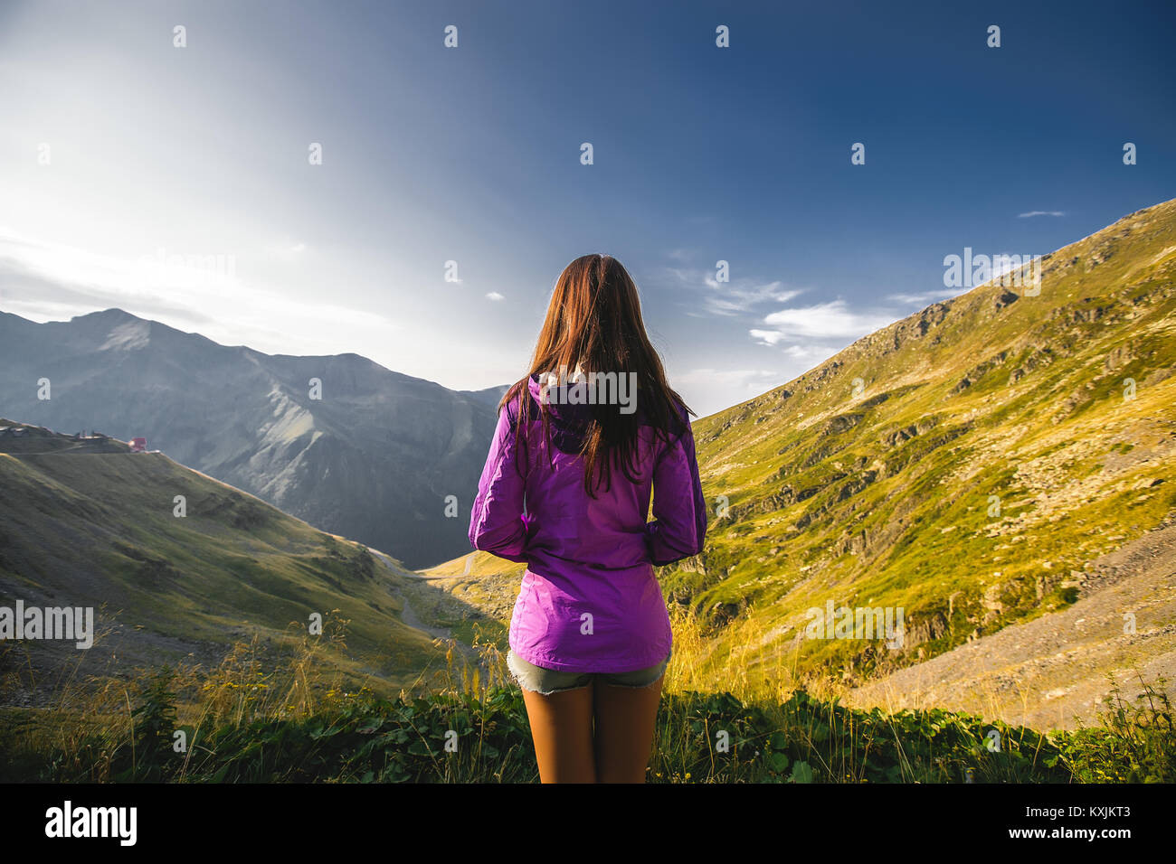 Rear view of young woman looking out over mountain scene, Draja, Vaslui ...