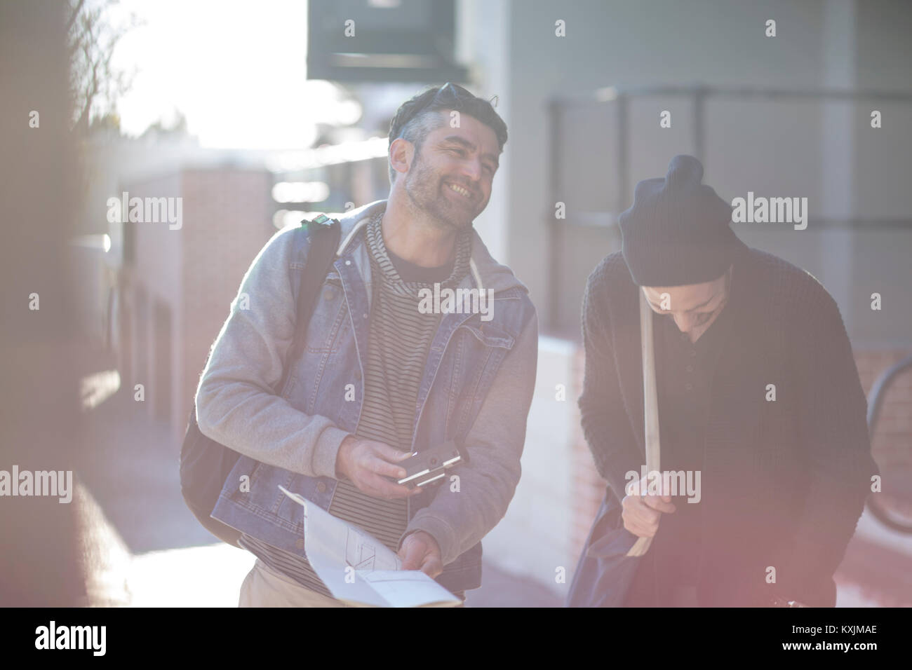 Two men in street, laughing together Stock Photo - Alamy