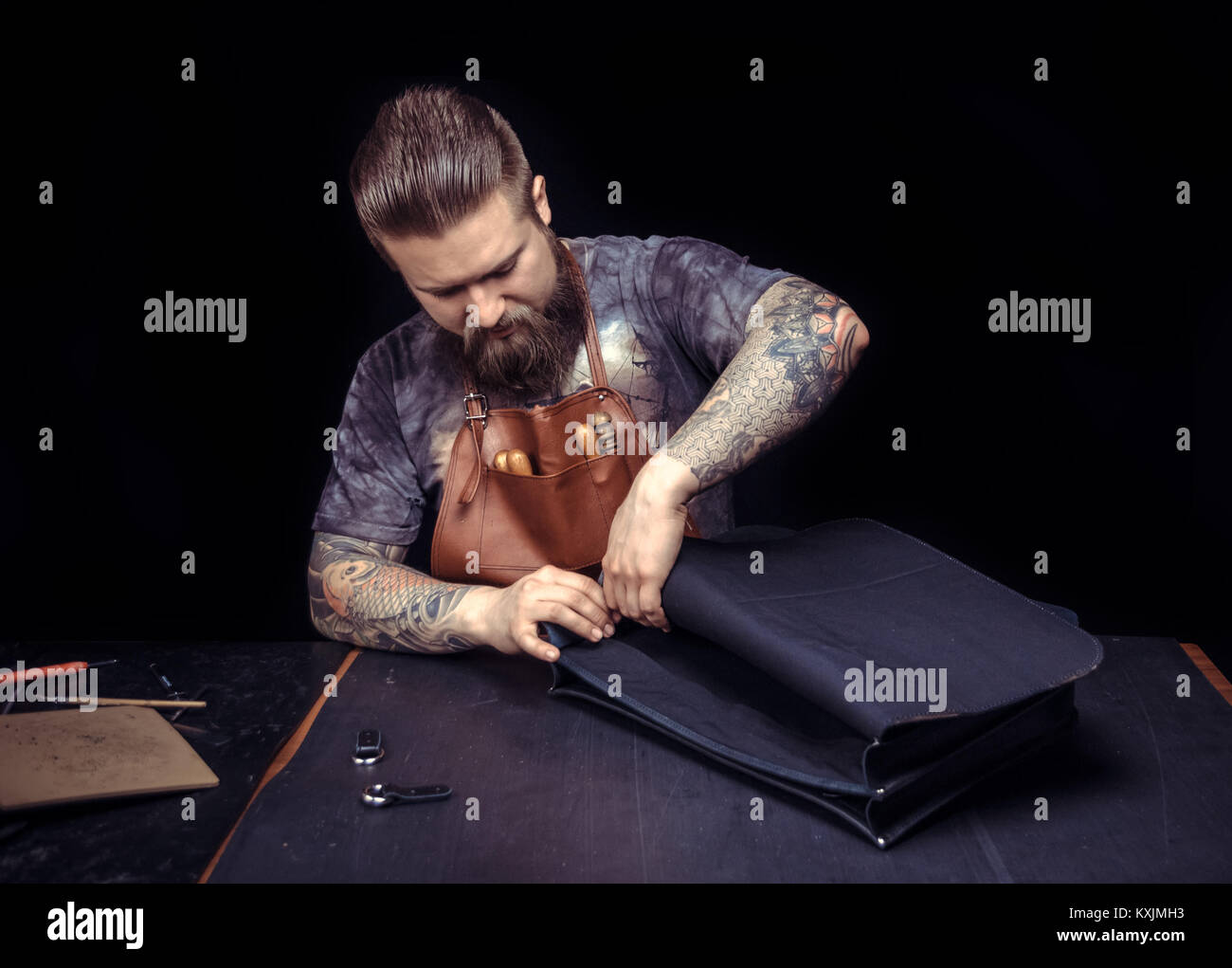 Currier of leather creating a new leather product in studio Stock Photo ...