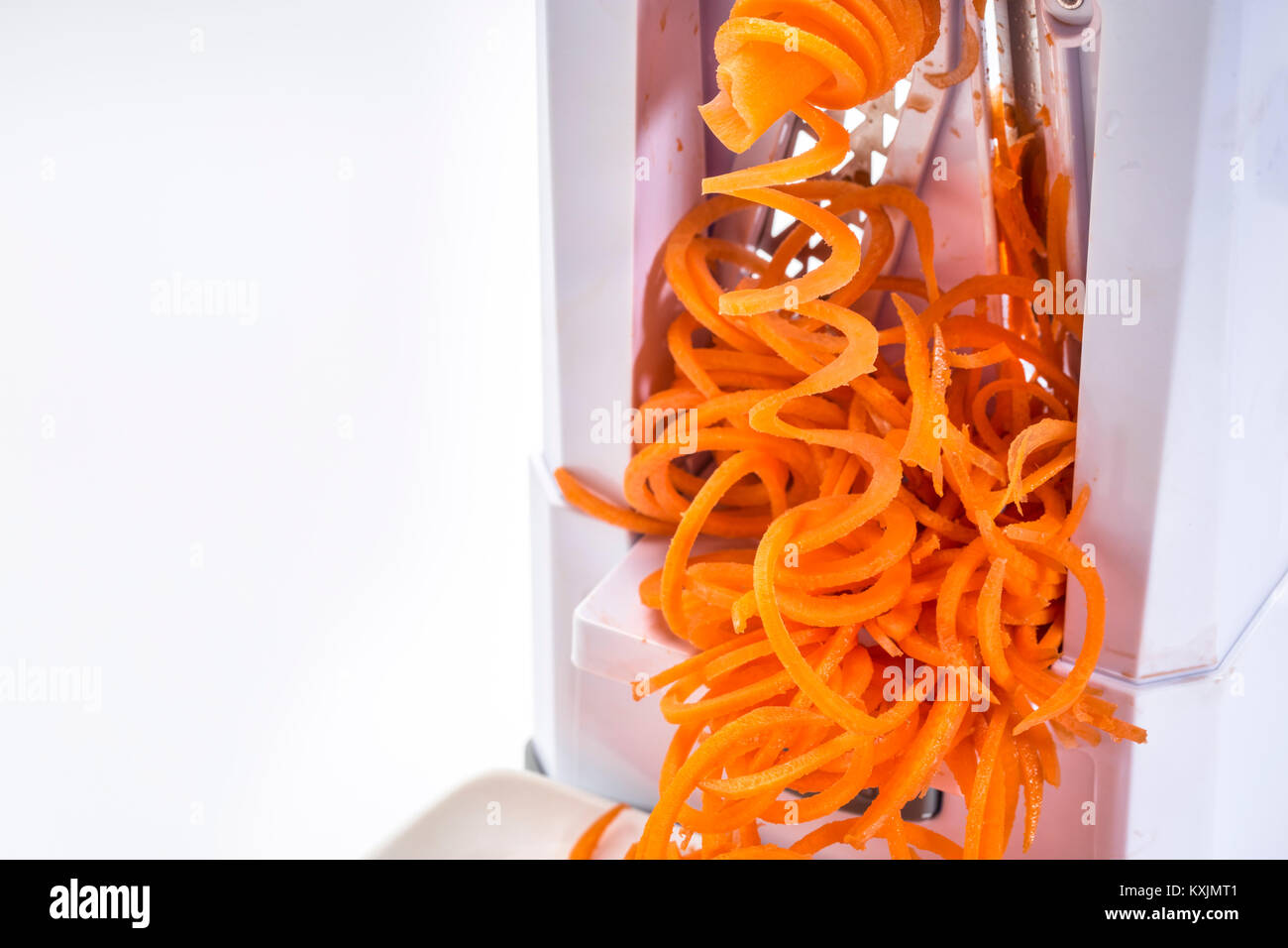 fresh raw carrot being processed with spiralizer (spiral slicer Stock ...