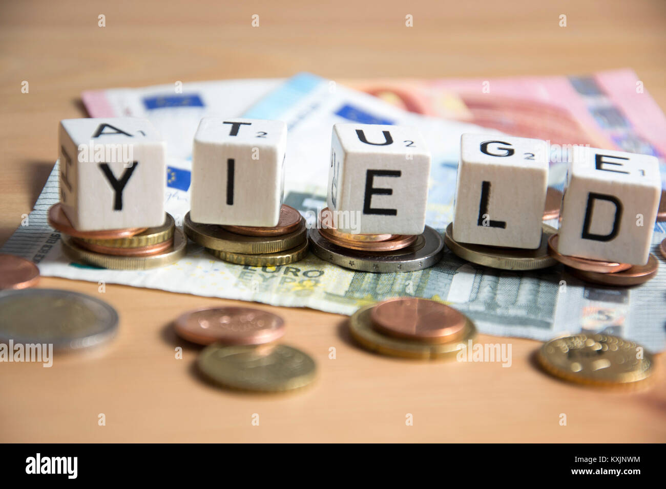 Yield word written on wood cube Stock Photo - Alamy