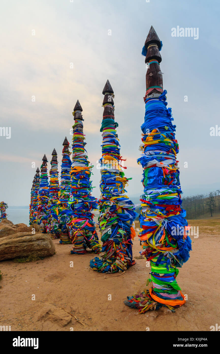 Wooden ritual pillars with colorful ribbons Hadak on cape Burkhan in ...