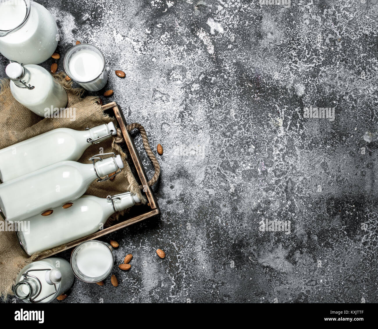 Milk background. Fresh milk in a wooden tray. On a rustic background ...