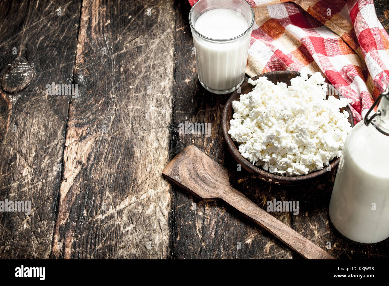 Cottage cheese from fresh cow milk. On a wooden background Stock Photo ...