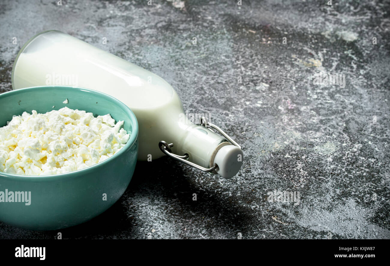 Cottage cheese and natural cow milk. On a rustic background Stock Photo ...