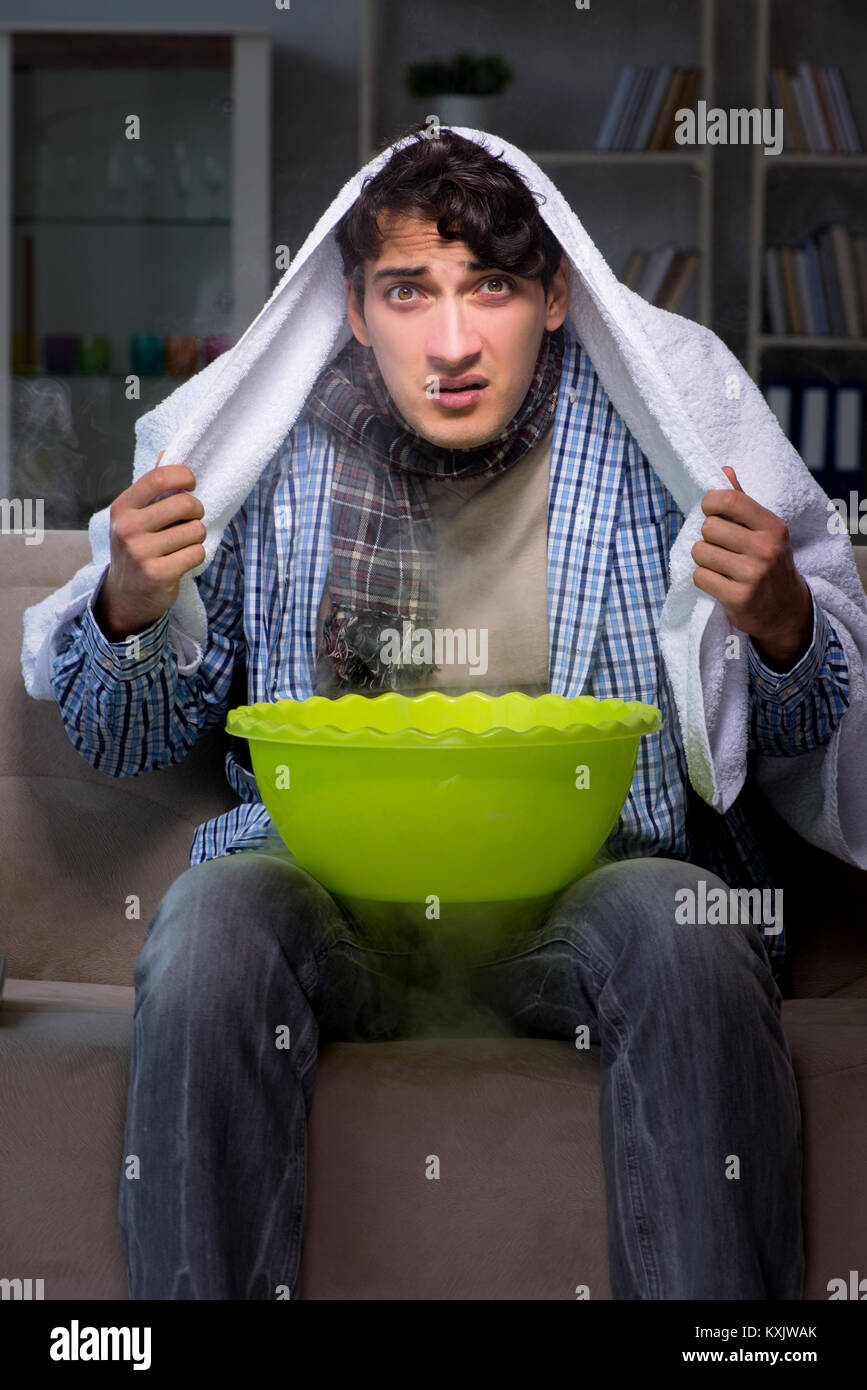 Sick man doing inhalation at night in home Stock Photo - Alamy