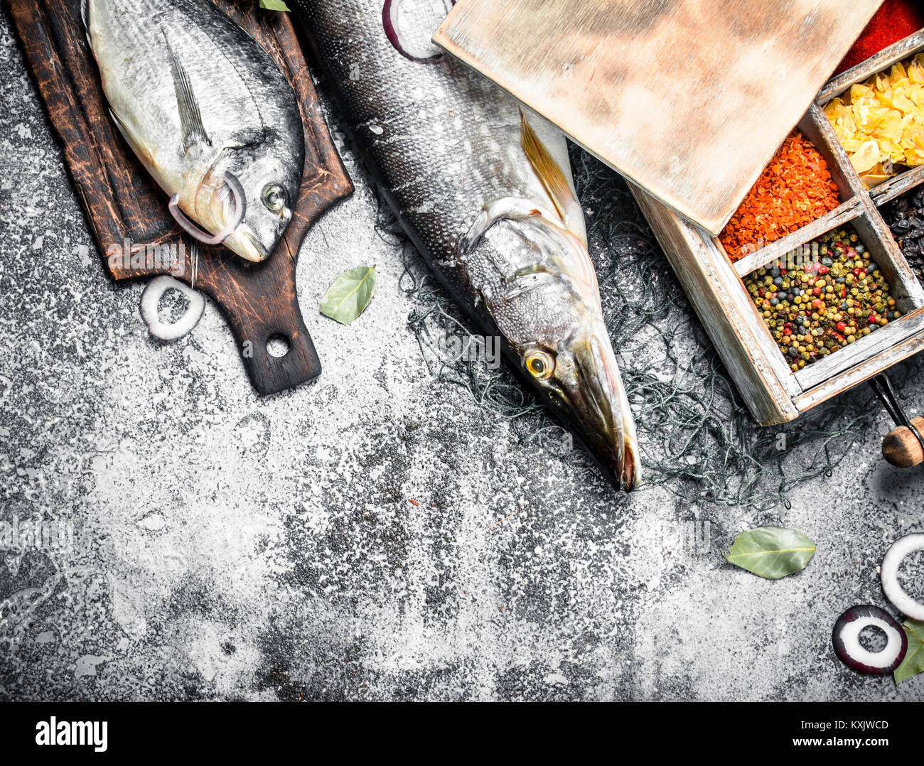 Fresh unprepared fish with spices. On a rustic background Stock Photo ...