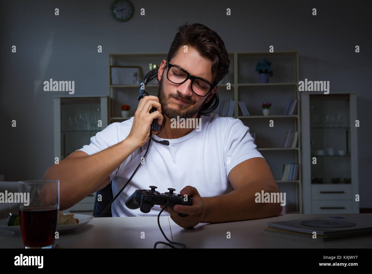 Young man playing games long hours late in the office Stock Photo - Alamy