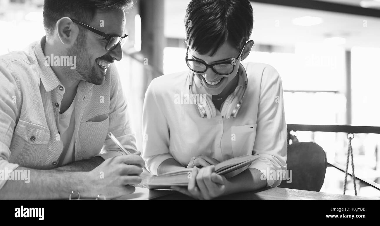 Happy couple studying in library Stock Photo - Alamy