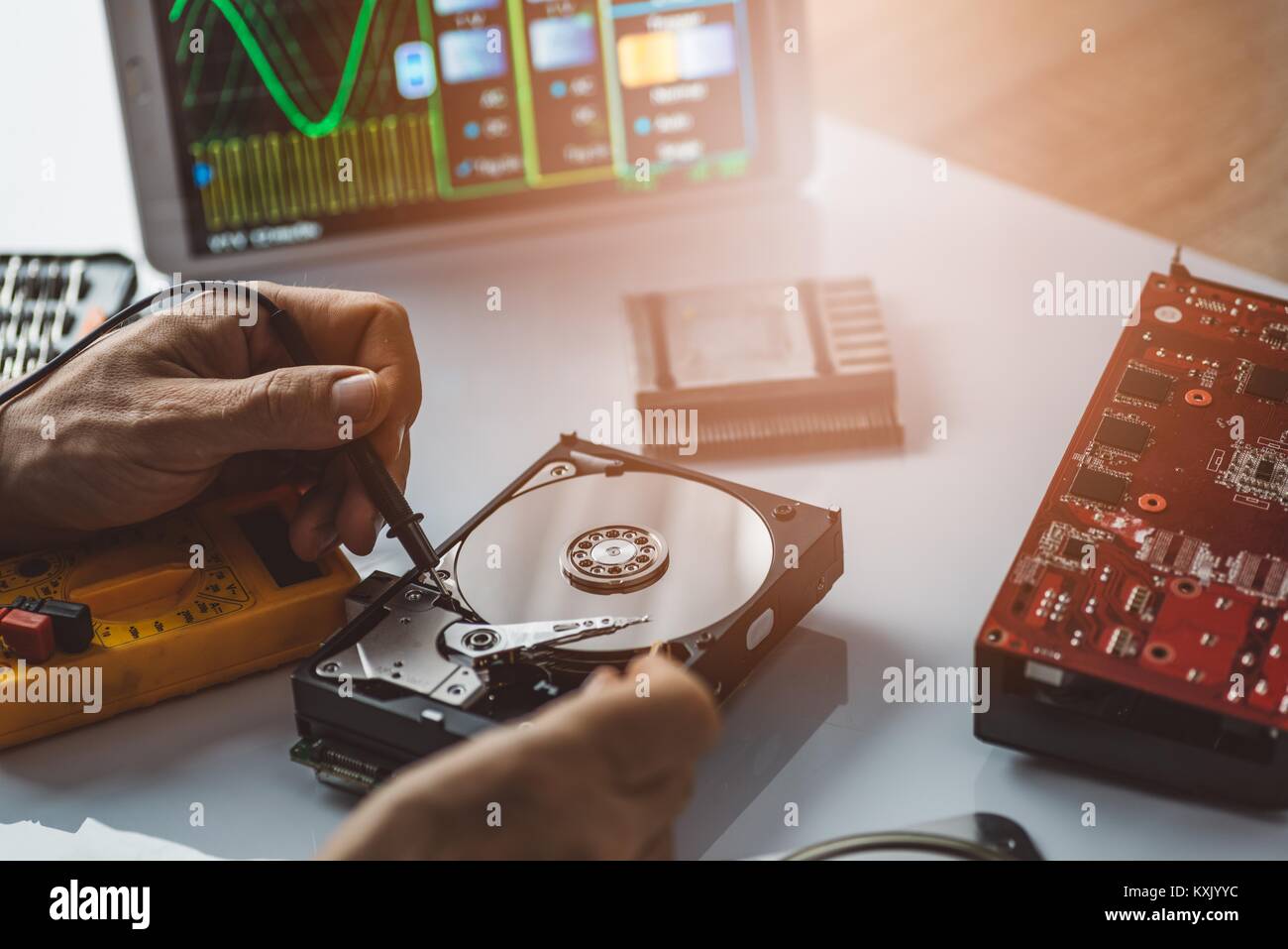 Technician repairing broken hard disk drive. Data recovery concept ...