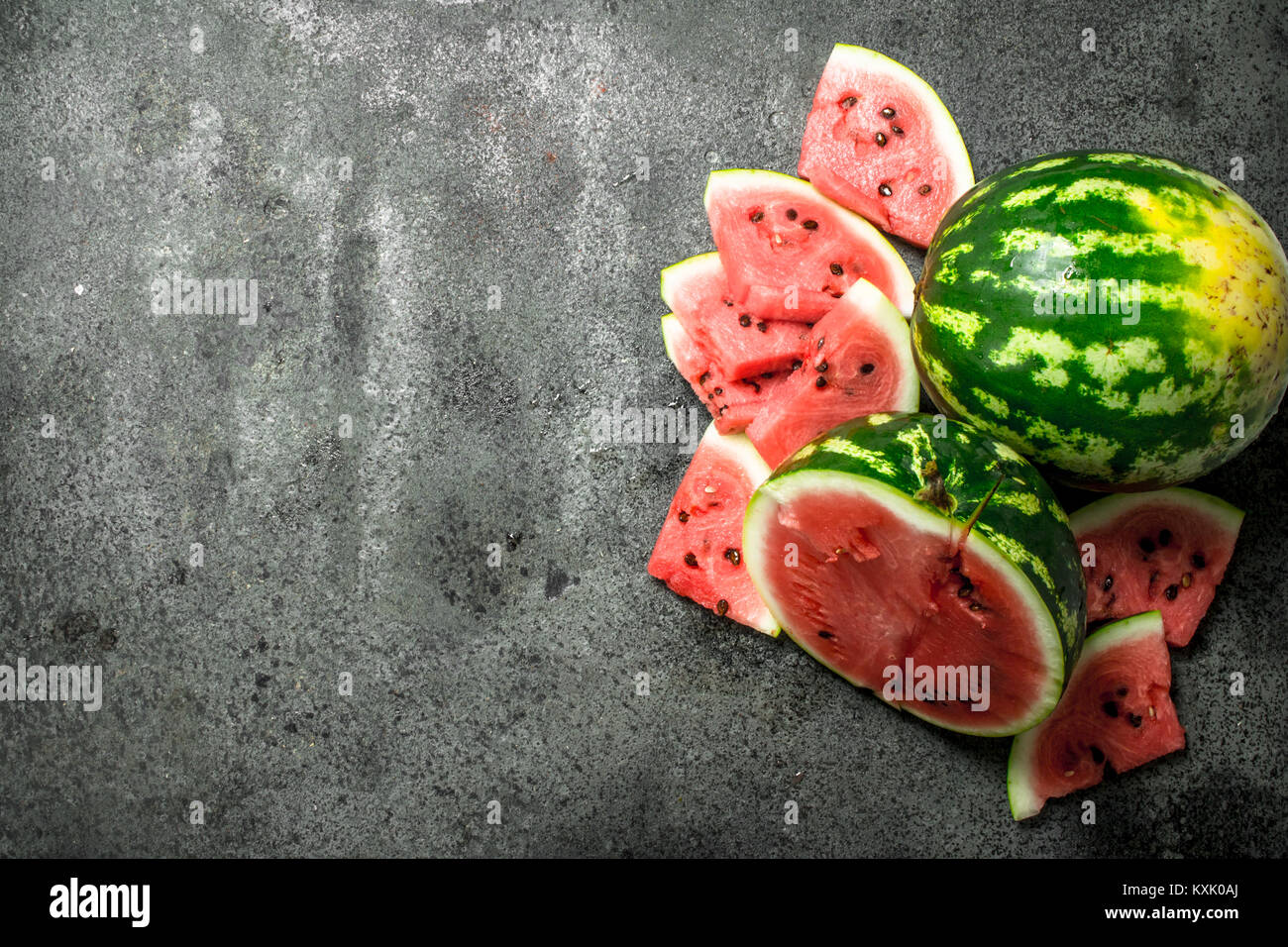 Fresh slices of watermelon. On a rustic background Stock Photo - Alamy