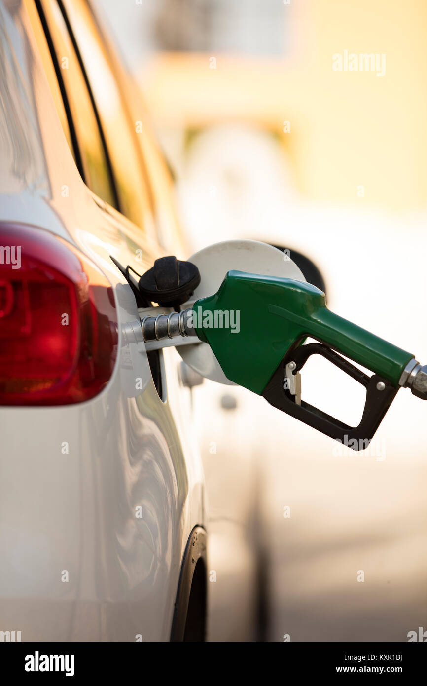 white car at gas station being filled with fuel Stock Photo - Alamy