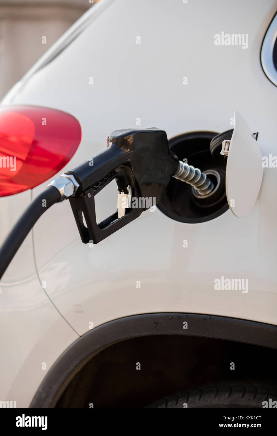 white car at gas station being filled with fuel Stock Photo - Alamy