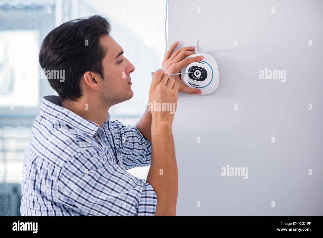 Man installing surveillance CCTV cameras at home Stock Photo - Alamy