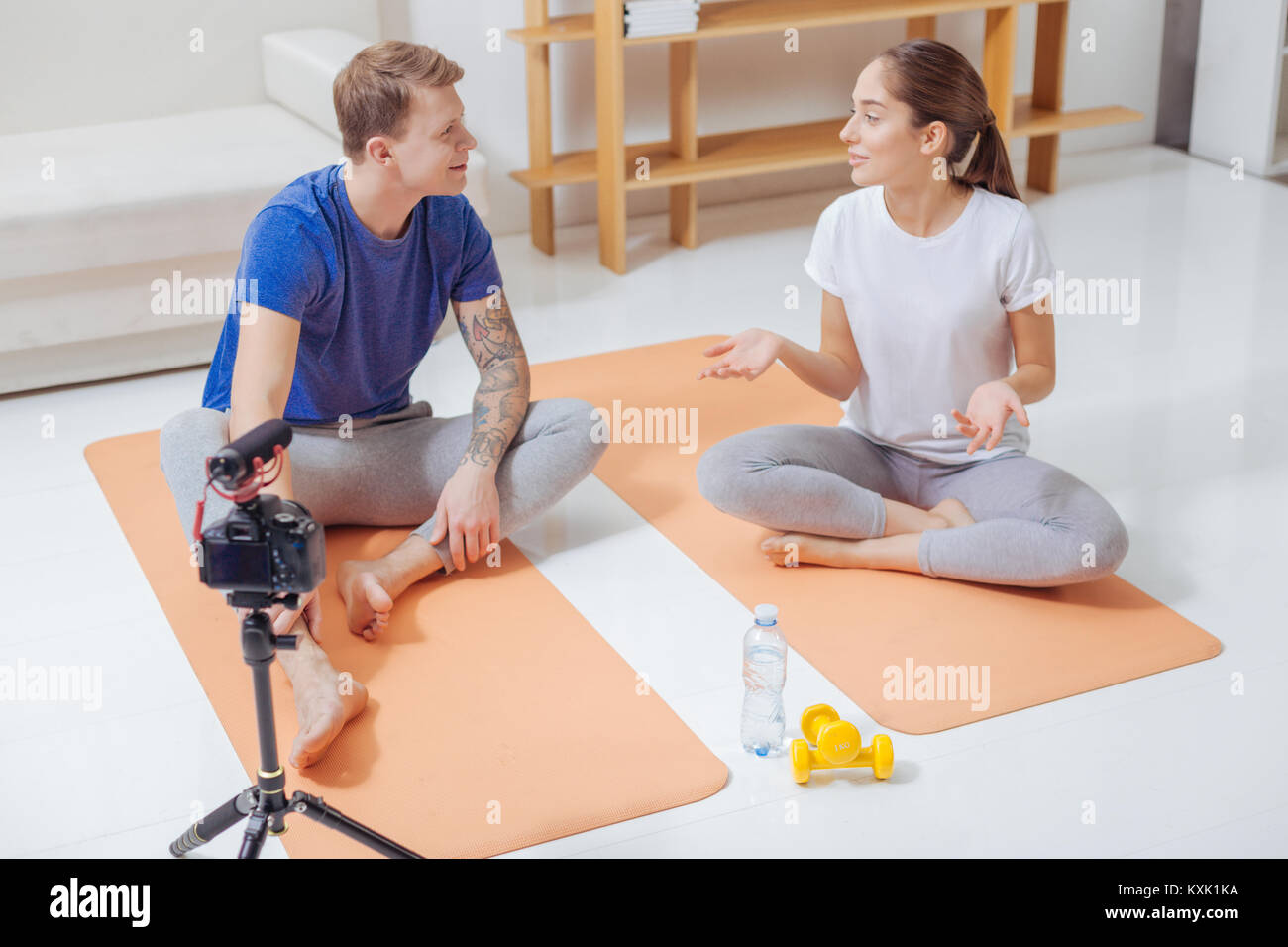 Interested man listening to his cheerful friend while recording a video ...