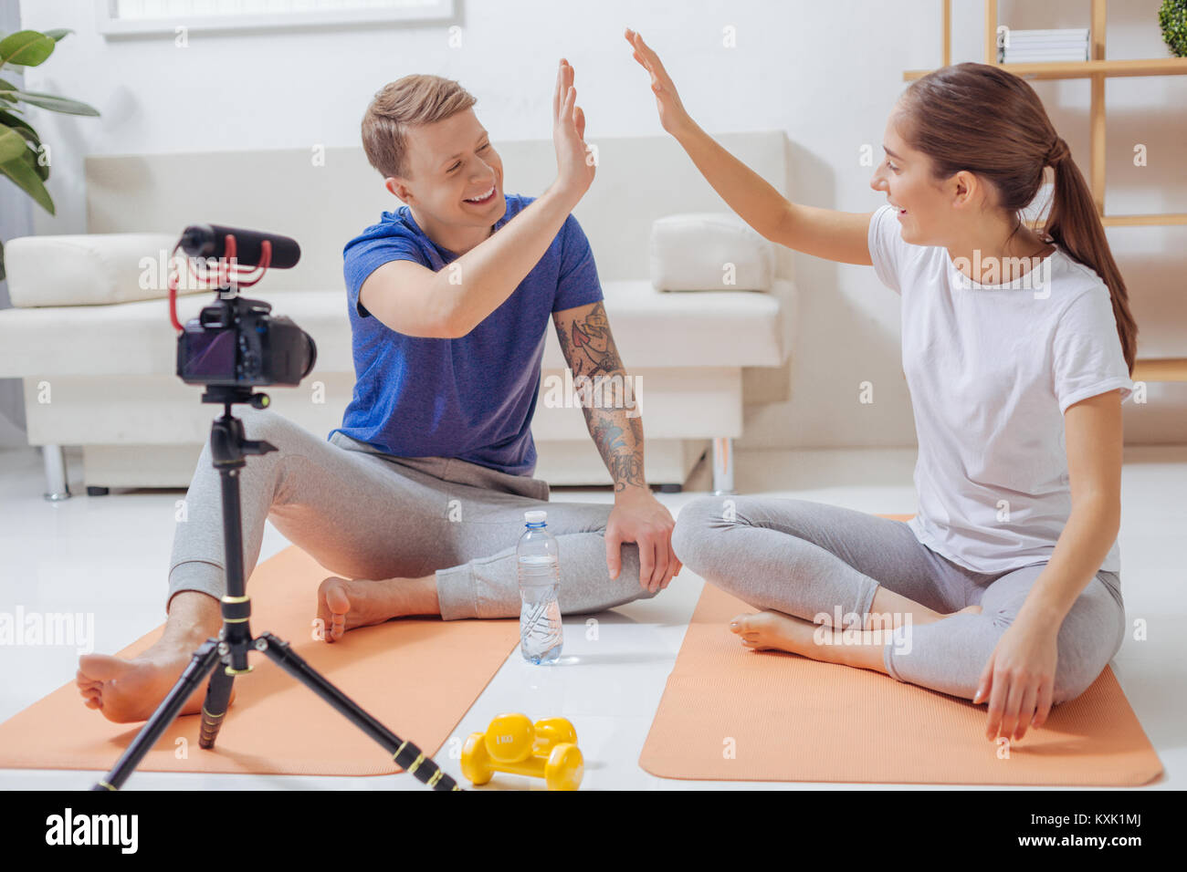Happy people smiling and giving five while recording a video Stock ...
