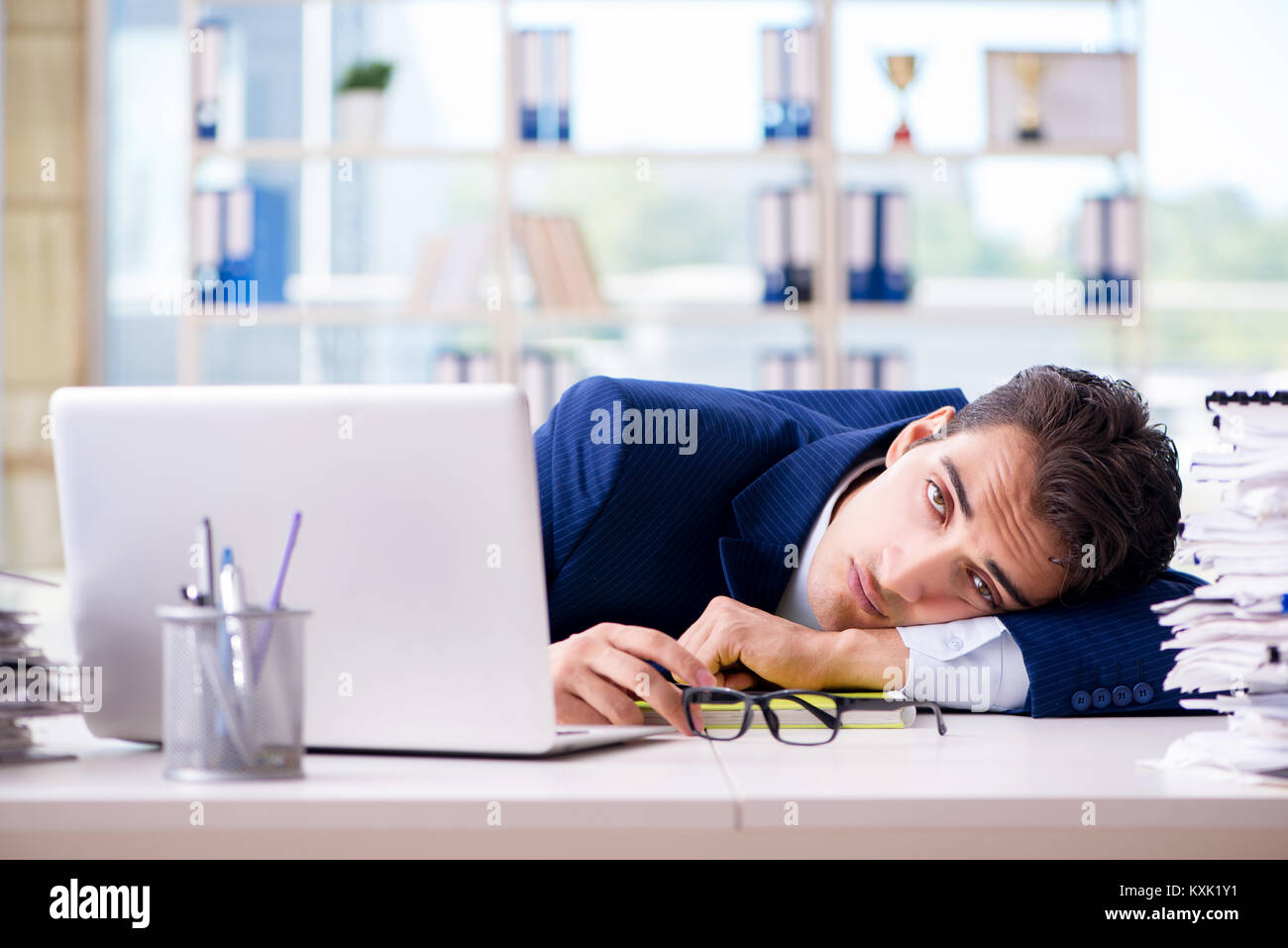 Tired businessman exhausted after hard work and excessive workload ...