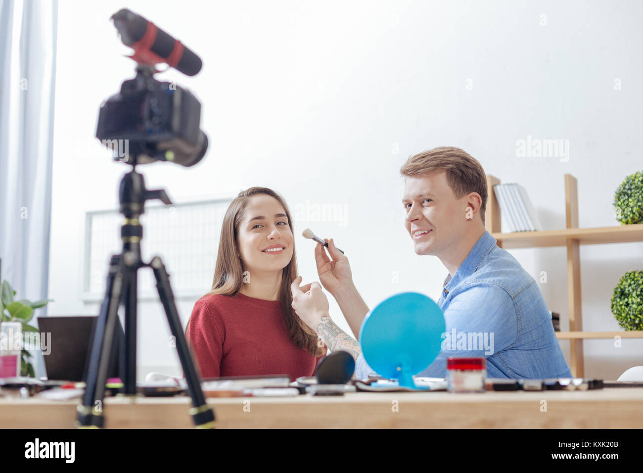 Happy colleagues smiling while testing facial powder together Stock ...