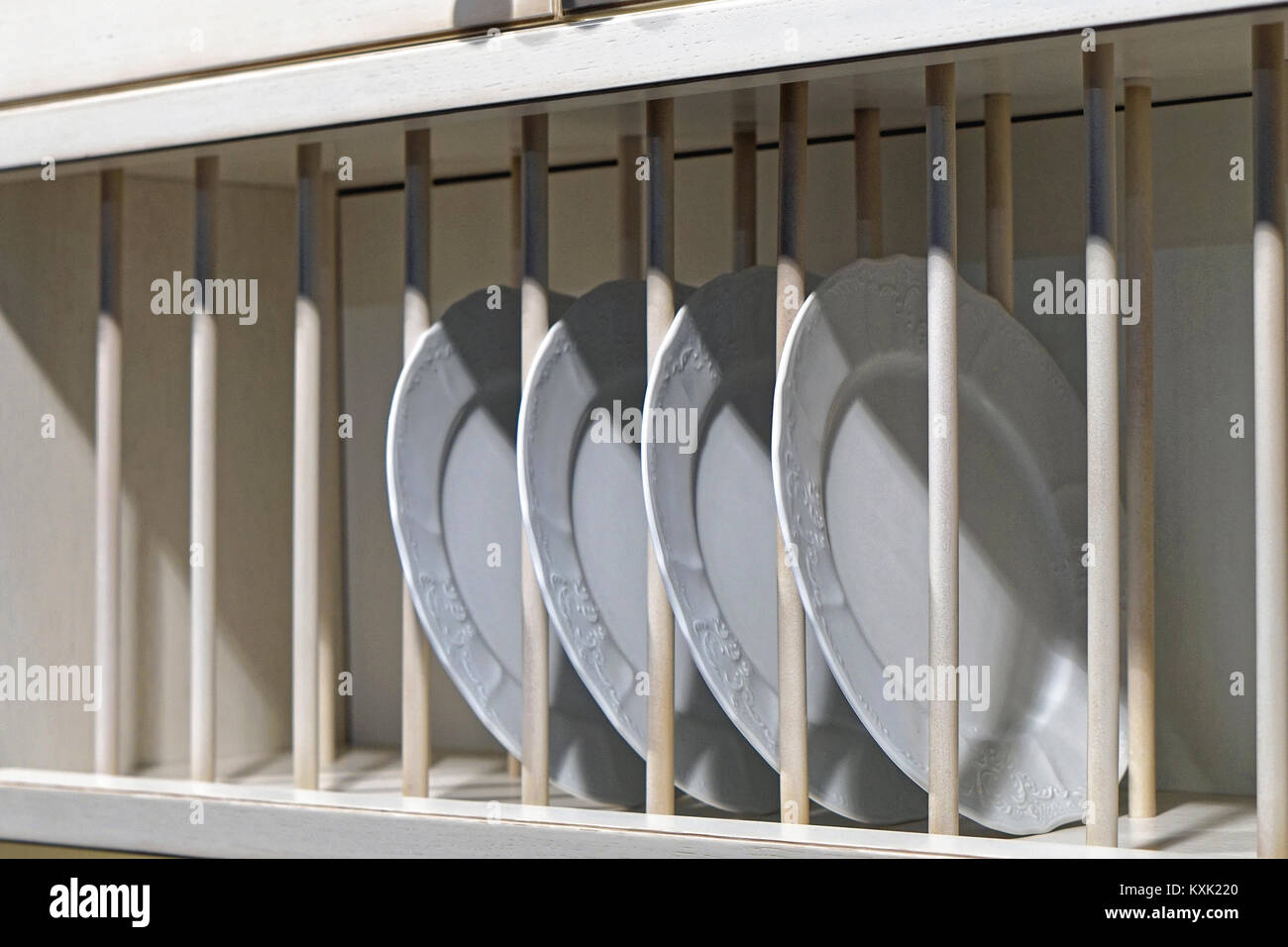 Ceramic dishes in rack shelf at home Stock Photo - Alamy