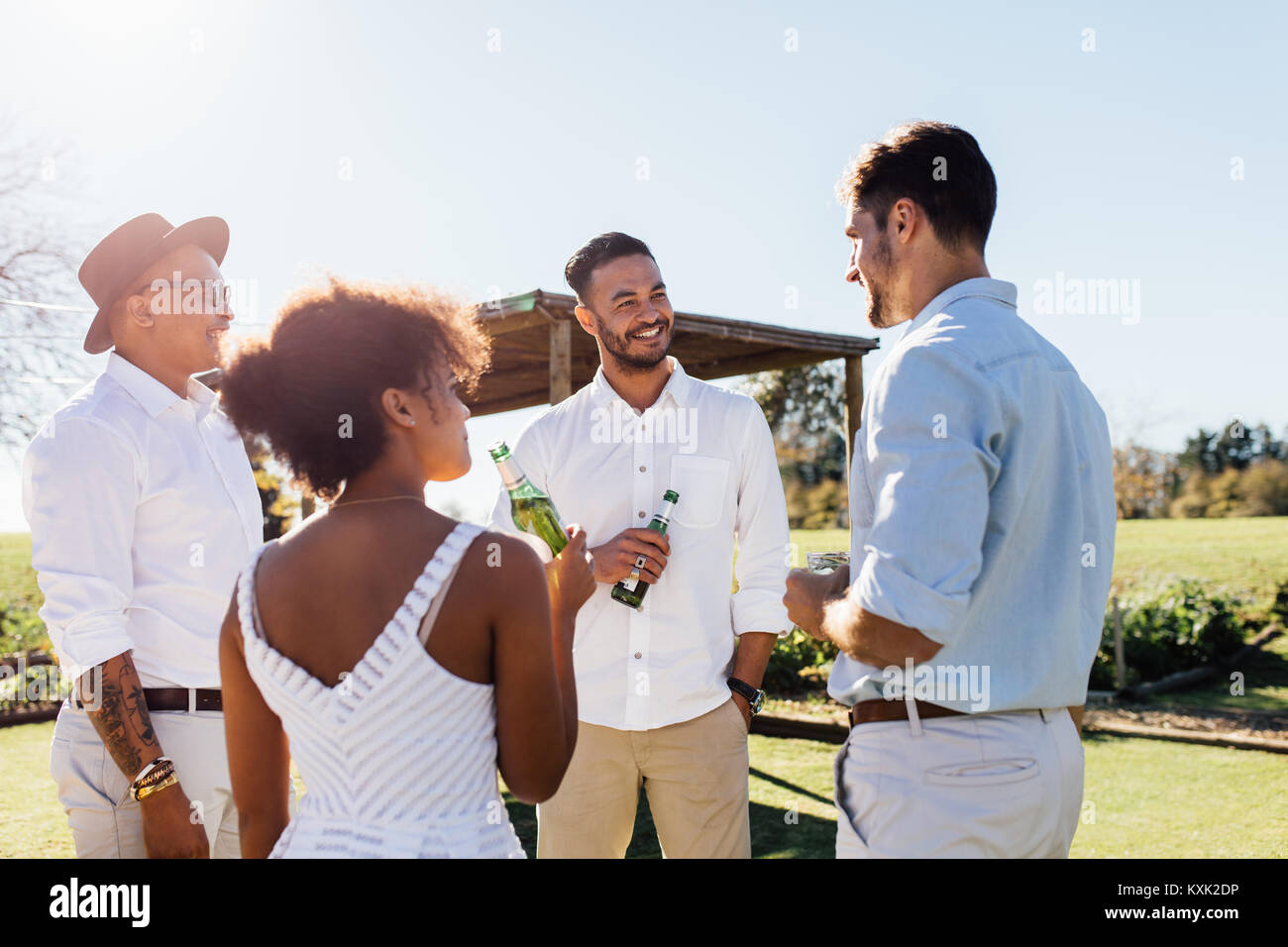 Group of multiethnic friends drinking and socialising. Young people ...