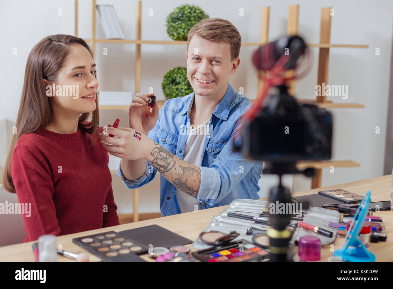 Reliable experienced person doing makeup for his assistant Stock Photo ...