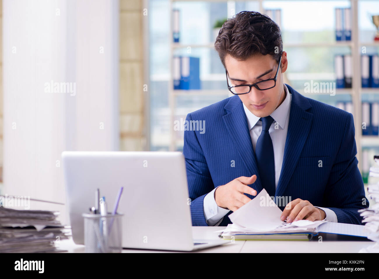 Businessman working with paperwork in the office Stock Photo - Alamy