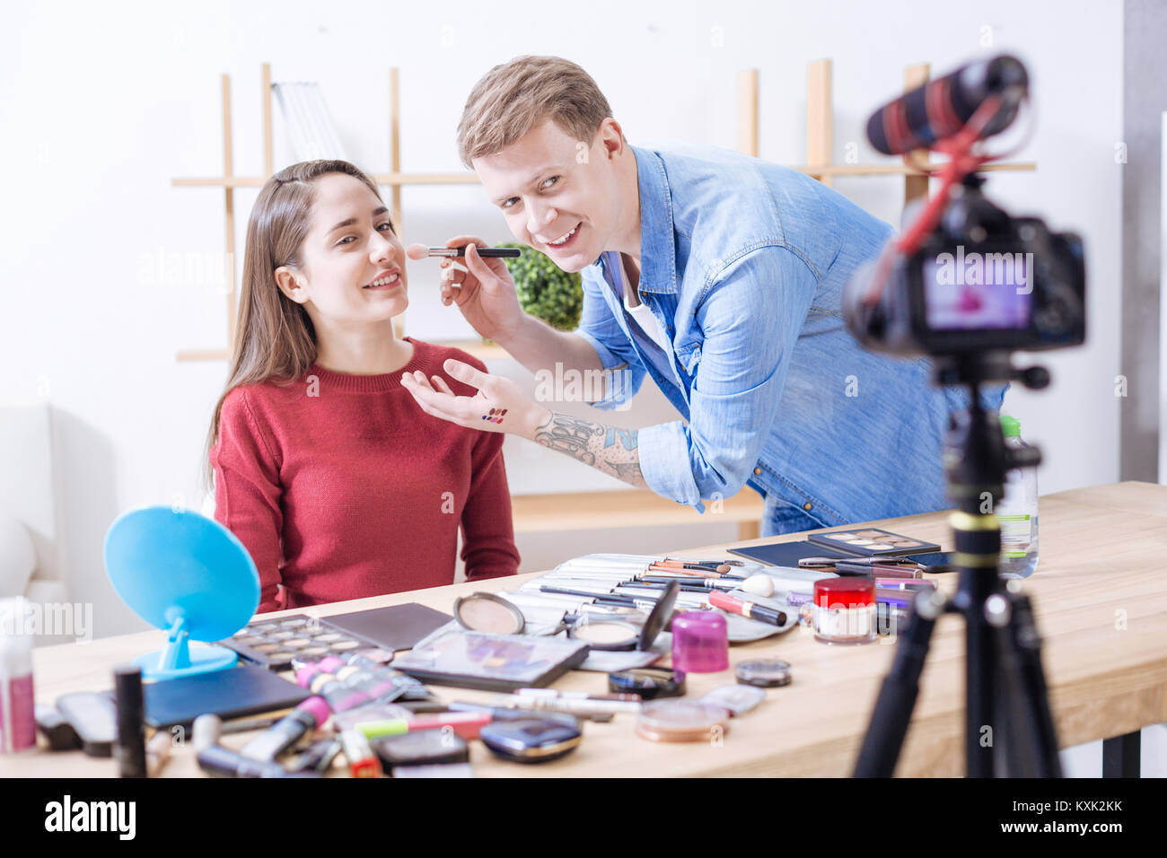 Handsome man helping young woman with her makeup Stock Photo - Alamy